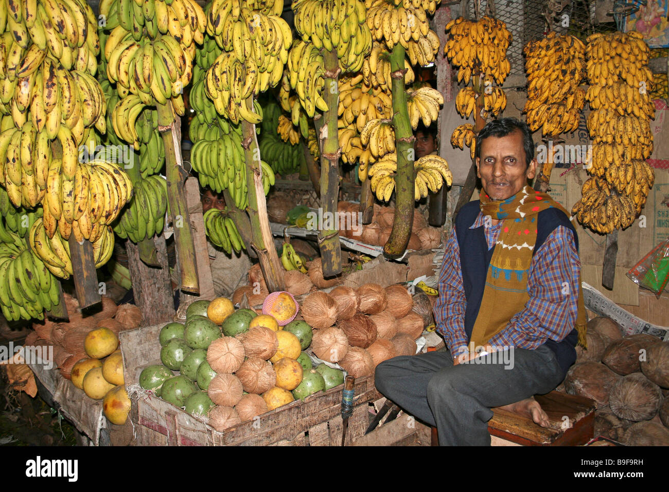 Indian Fruit Seller Surrounded By Bananas and Coconuts On His Market ...