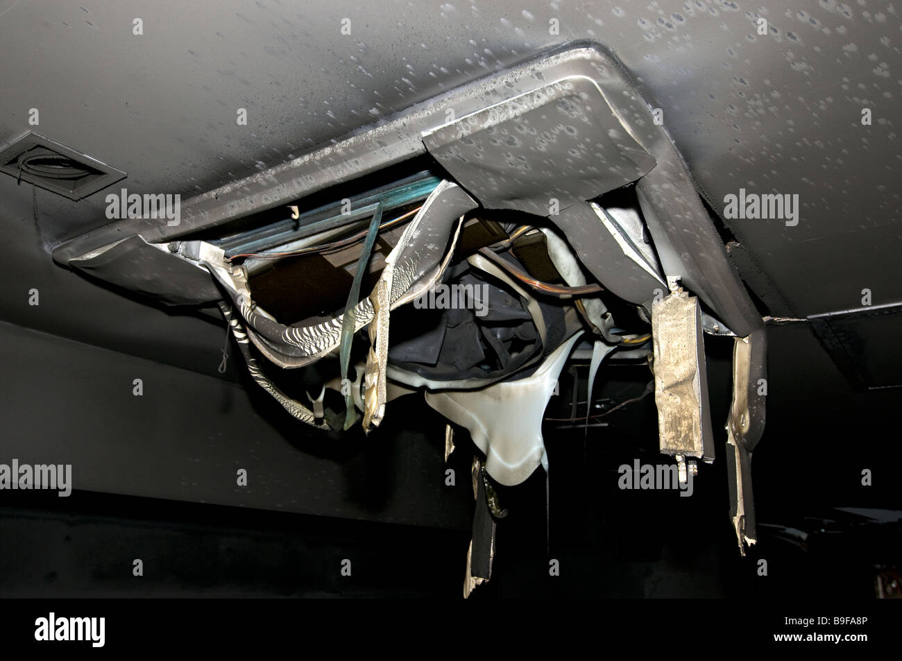 Melted air conditioning unit in office ceiling following fire Stock ...