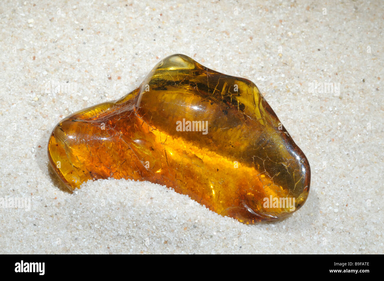 Amber on sand Stock Photo - Alamy