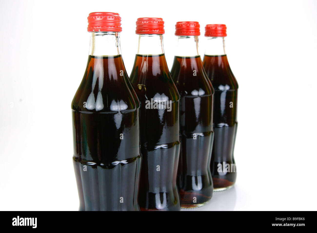 Cola bottles isolated against a white background Stock Photo - Alamy