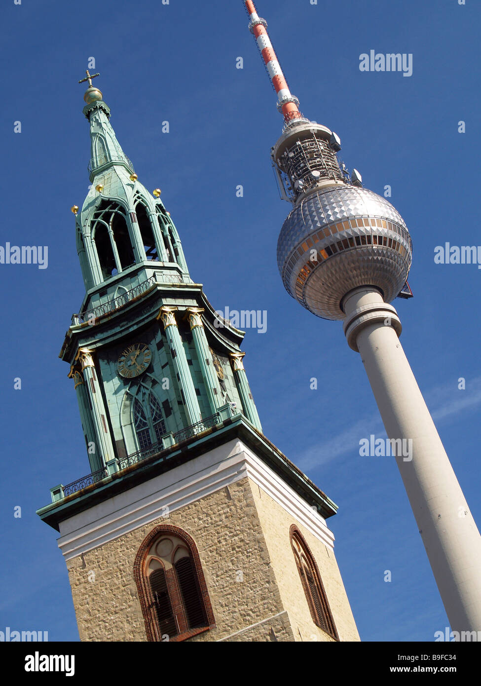Low angle view of communication tower with church spire Stock Photo - Alamy
