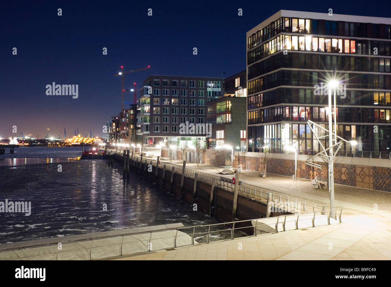 Buildings at waterfront lit up at night, Germany Stock Photo - Alamy