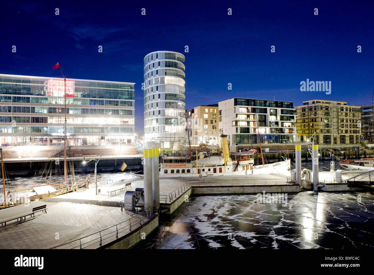 Buildings in city lit up at night, Germany Stock Photo - Alamy