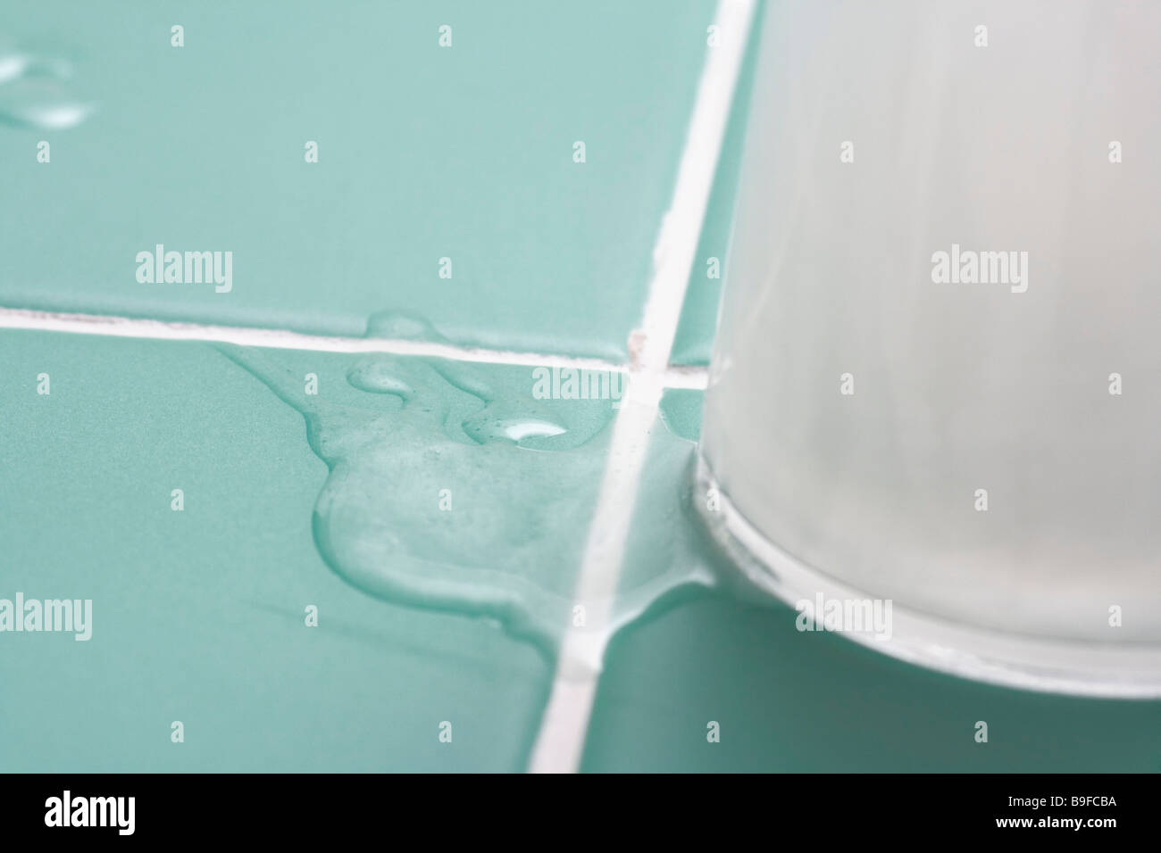 Close-up of water drops on tiled floor Stock Photo - Alamy