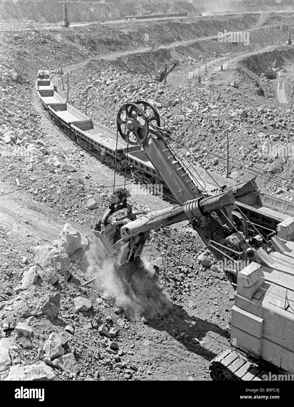 An excavator is loading copper ore onto railway platforms in Zlatoust ...