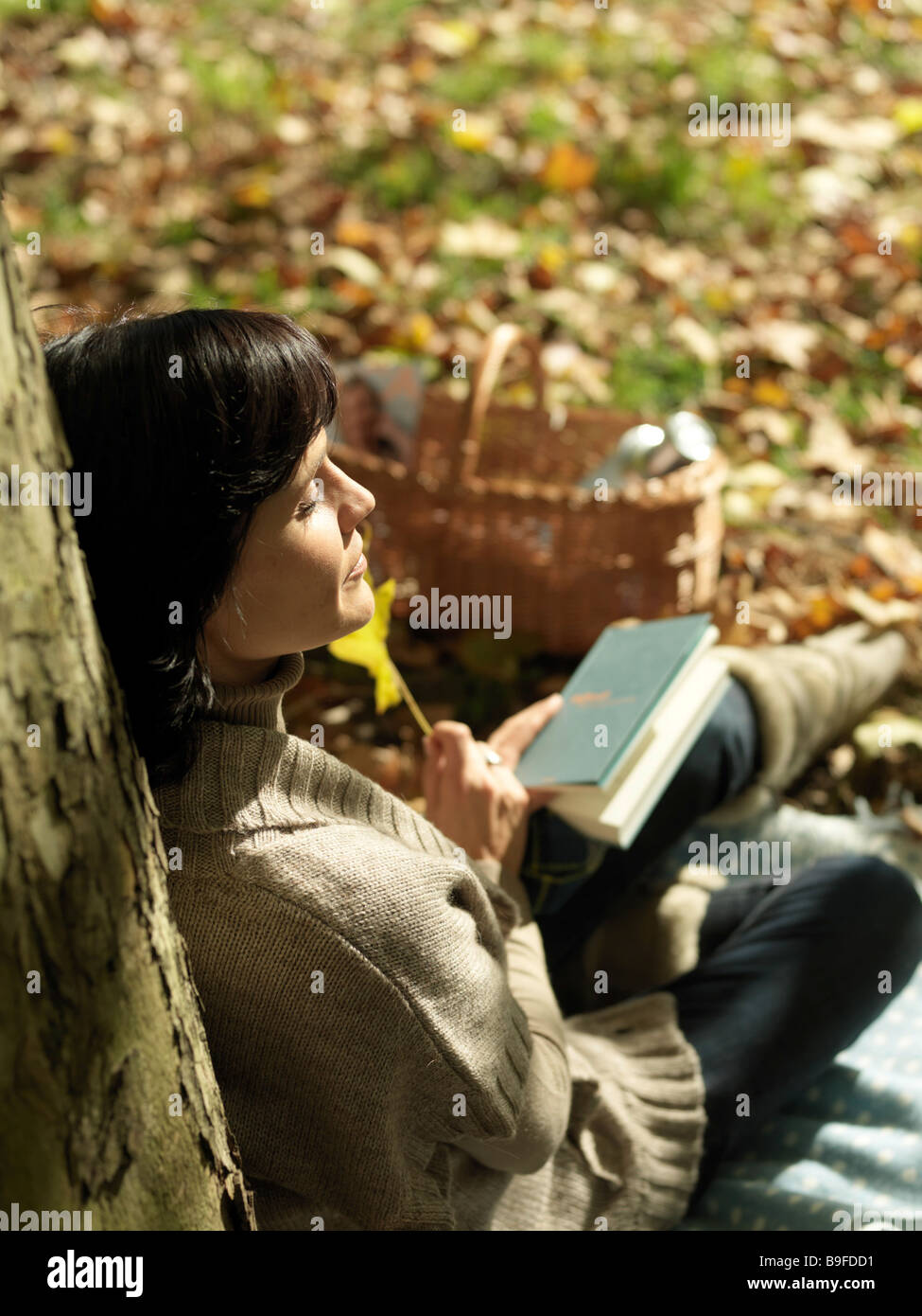 Seated against tree hi-res stock photography and images - Alamy