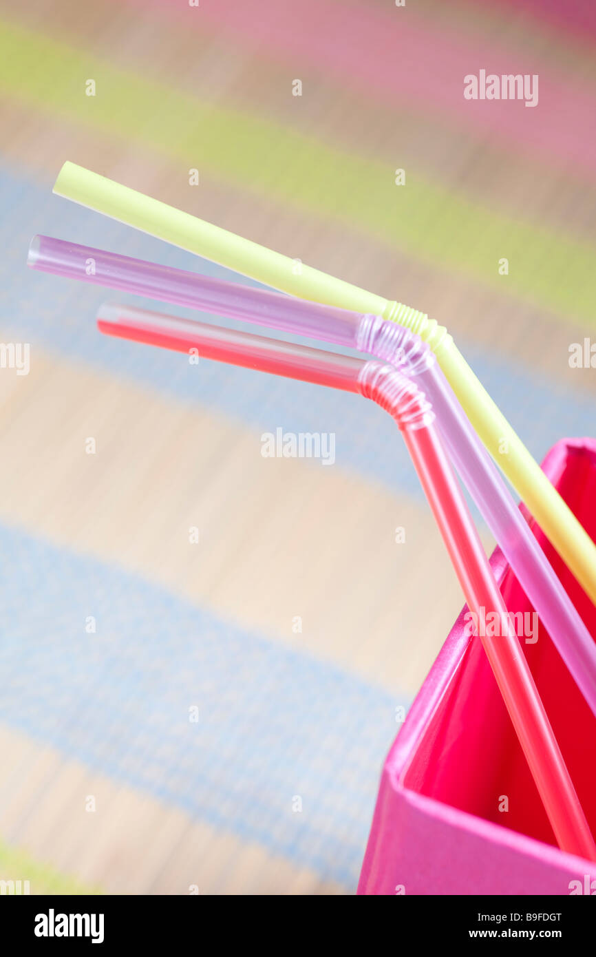 Colorful straws in pink container Stock Photo - Alamy
