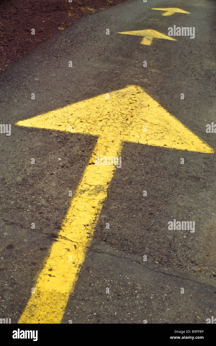 three 3 yellow taffic directional arrows point way out Stock Photo - Alamy
