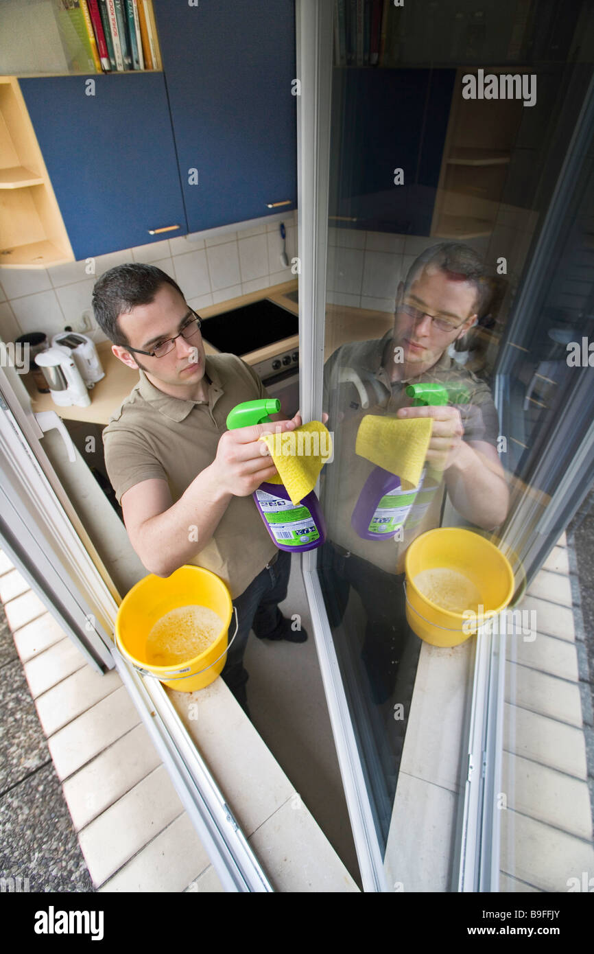 Young man cleaning the windows Stock Photo - Alamy