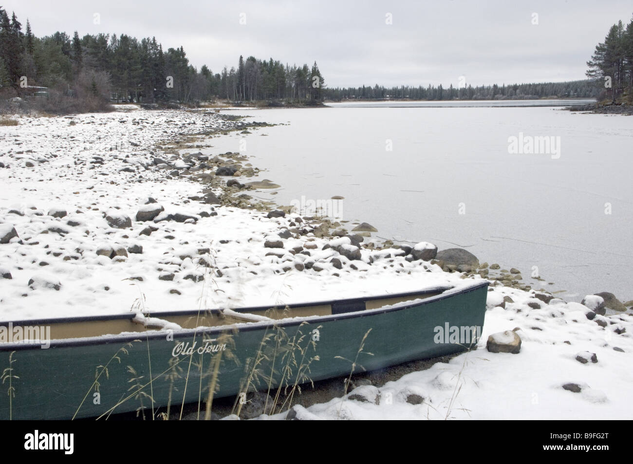 Sweden Kiruna riversides canoe winter Stock Photo - Alamy
