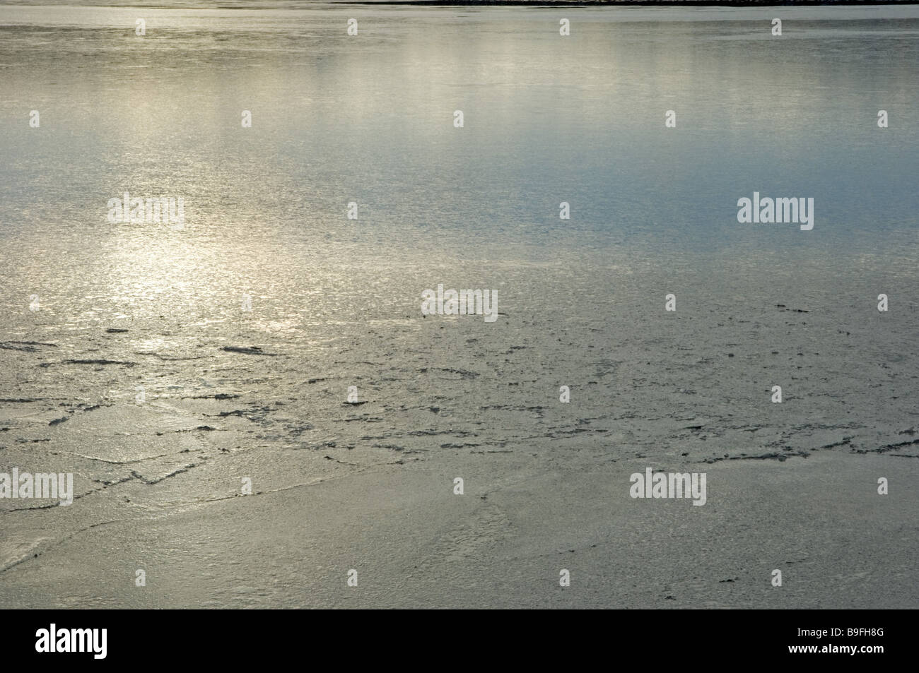 lake froze ice-surface light reflection winter Stock Photo - Alamy