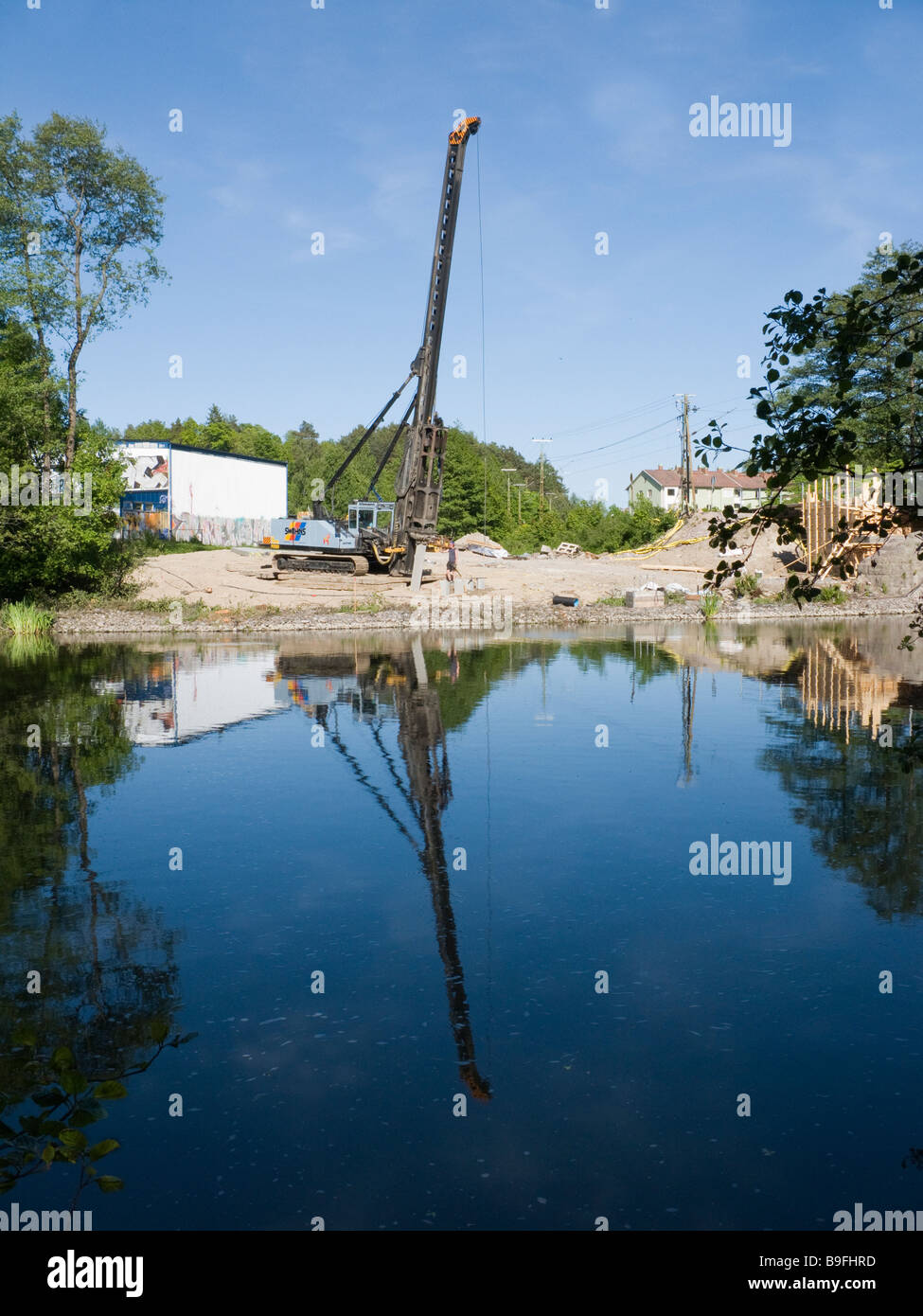 Pile driving machine, hammering poles down in the ground to stabilize ...