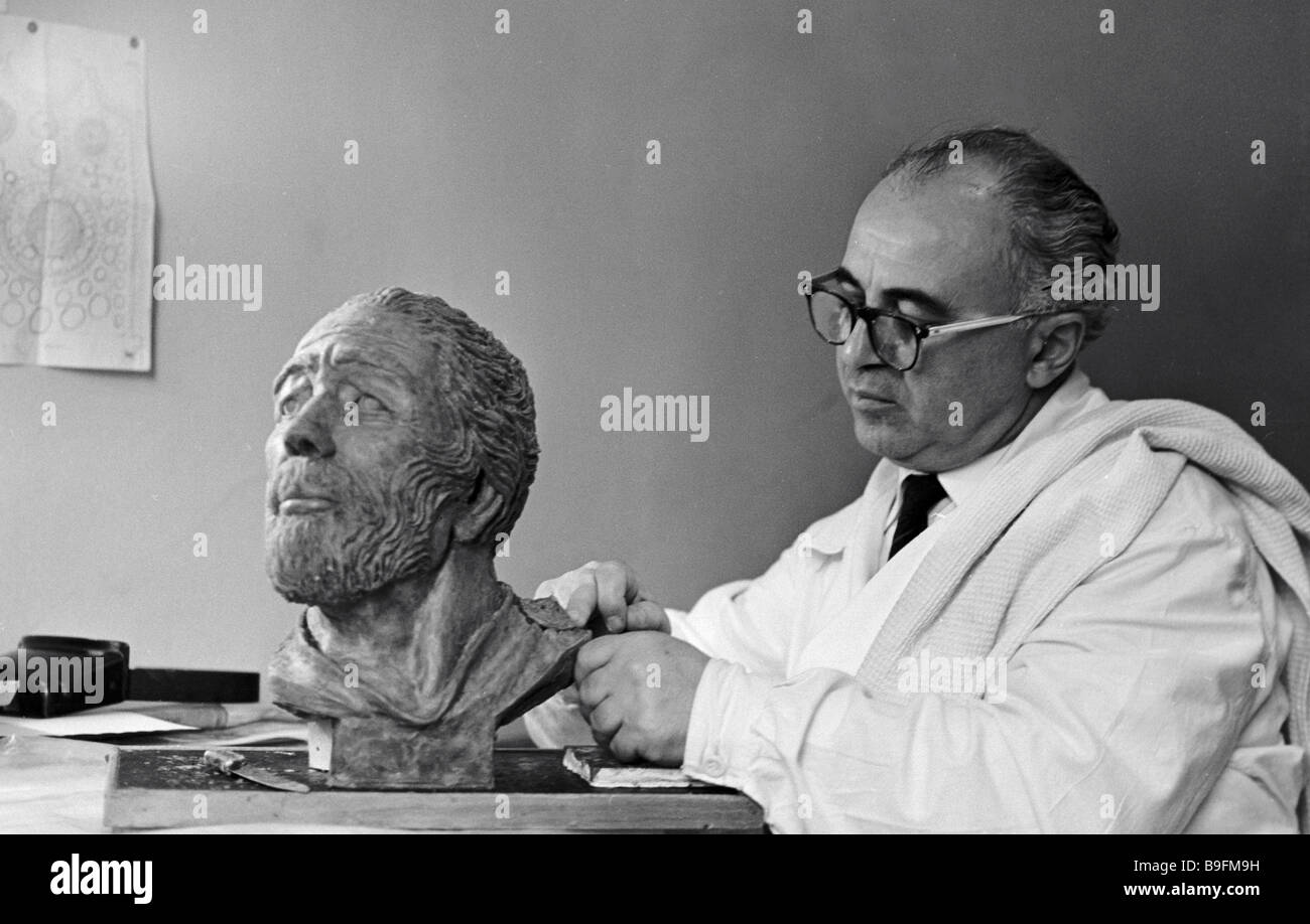 An anthropologist working on a sculptural portrait based on skull bones ...