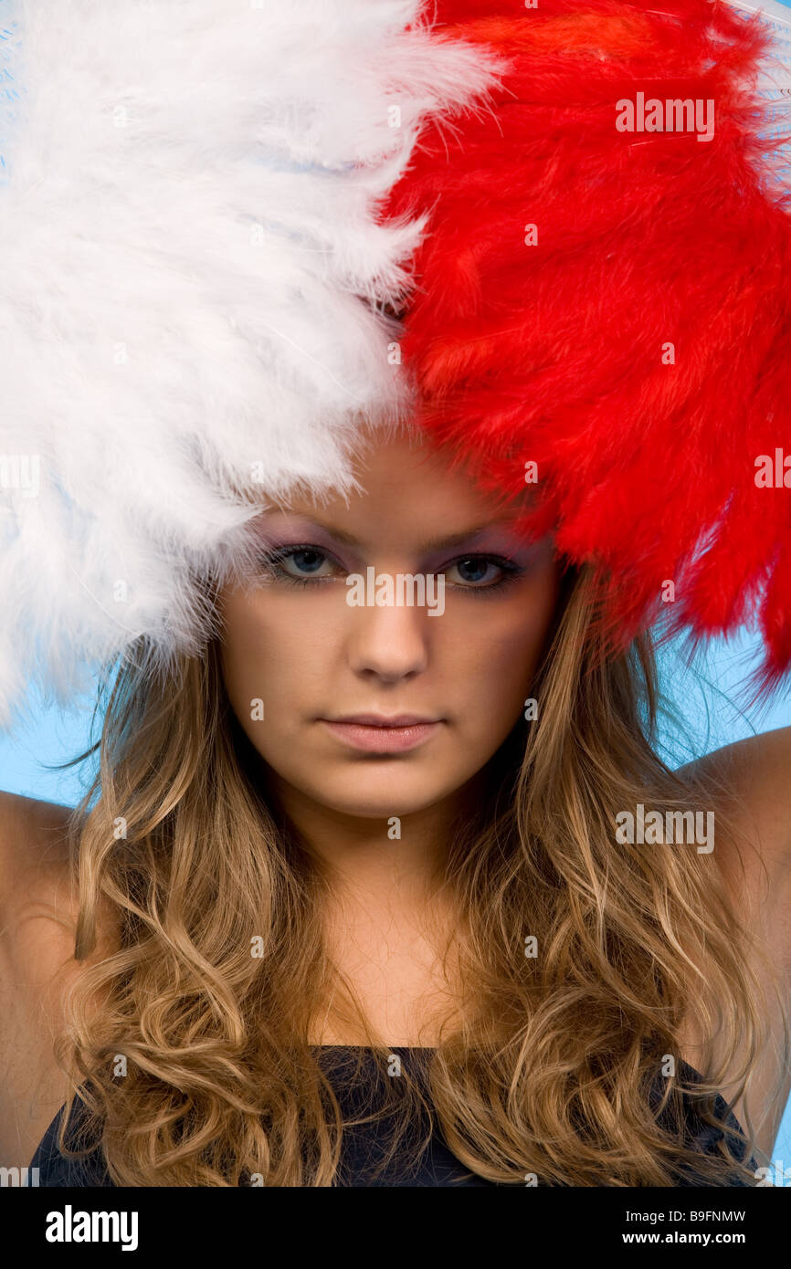 beautiful woman with two fans on a blue background Stock Photo - Alamy