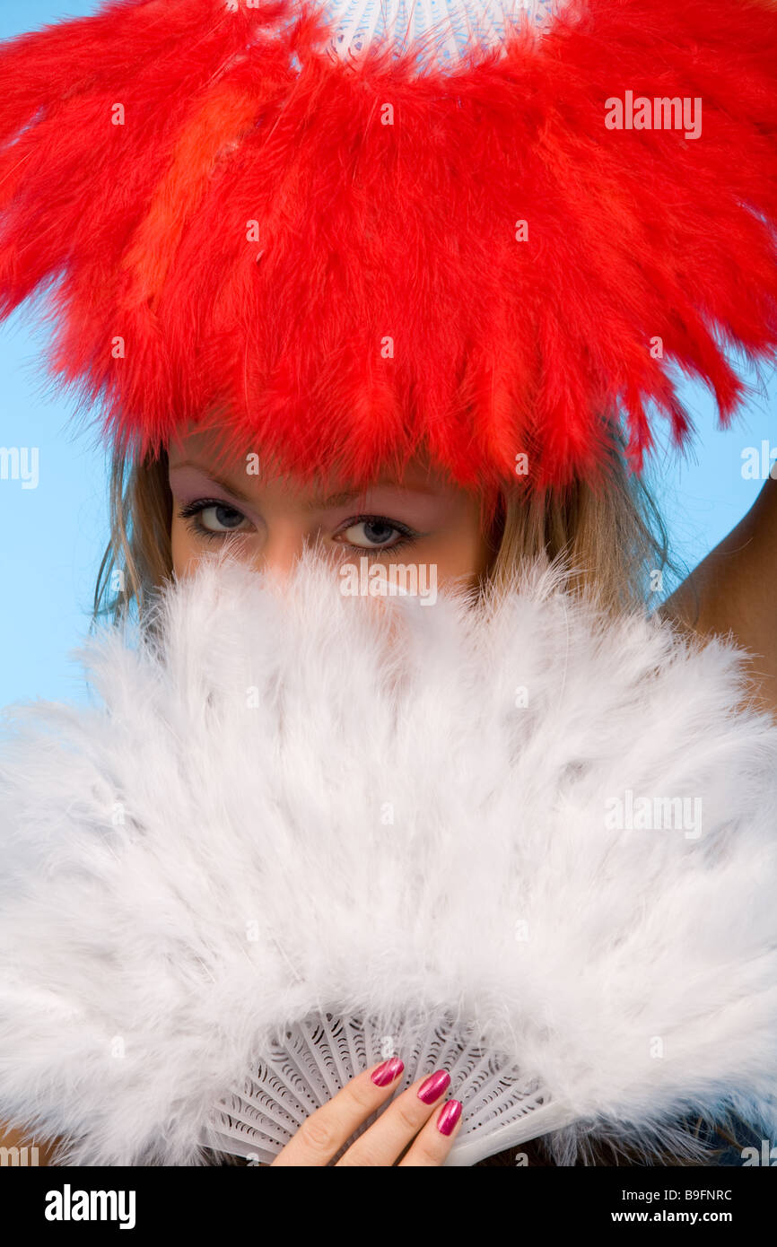 beautiful woman with two fans on a blue background Stock Photo - Alamy