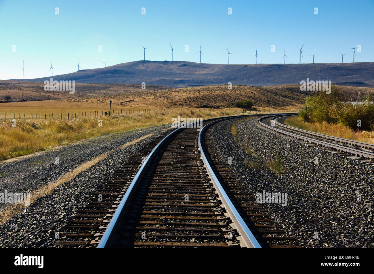 Wind turbines in the desert behind railroad tracks Stock Photo - Alamy