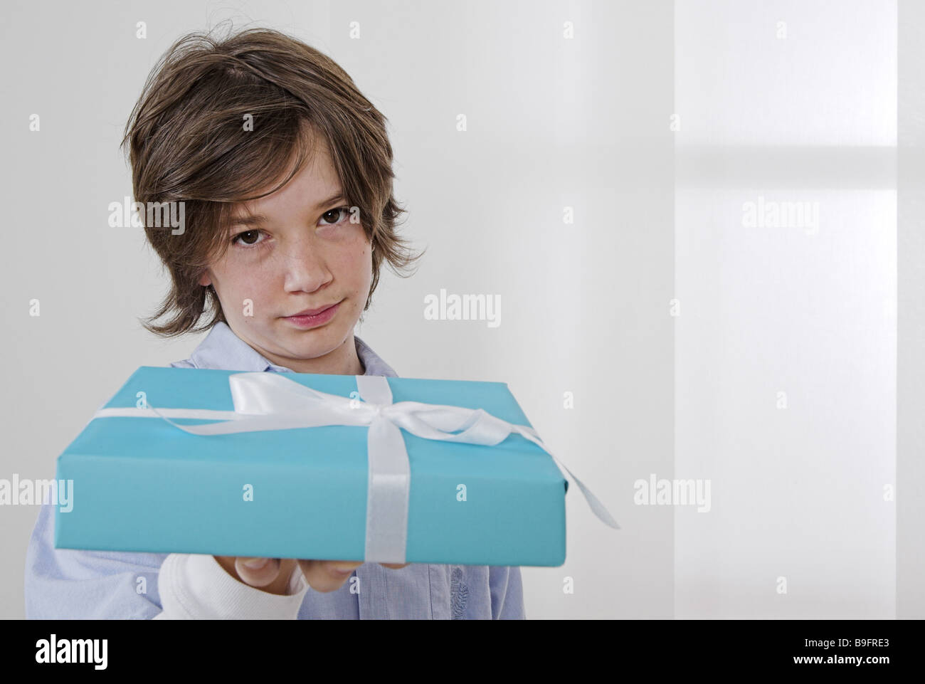 Teenager boy seriously gift giving portrait people teenagers holding ...