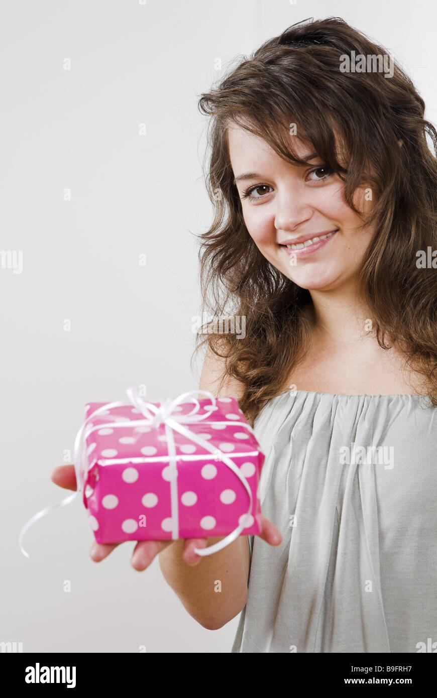 Teenager girl cheerfully gift smile gives semi-portrait people teenager ...