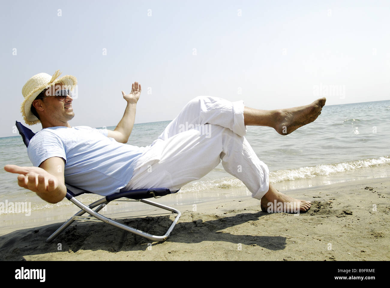 Man middle age beach 30-40 years 35-30 years stretches observing poor ...