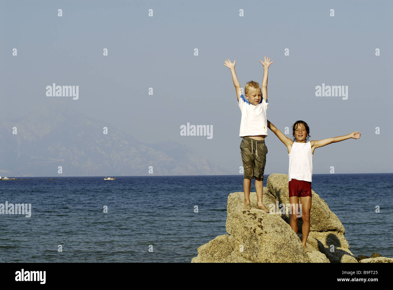 Children stands rocks sea Stock Photo - Alamy
