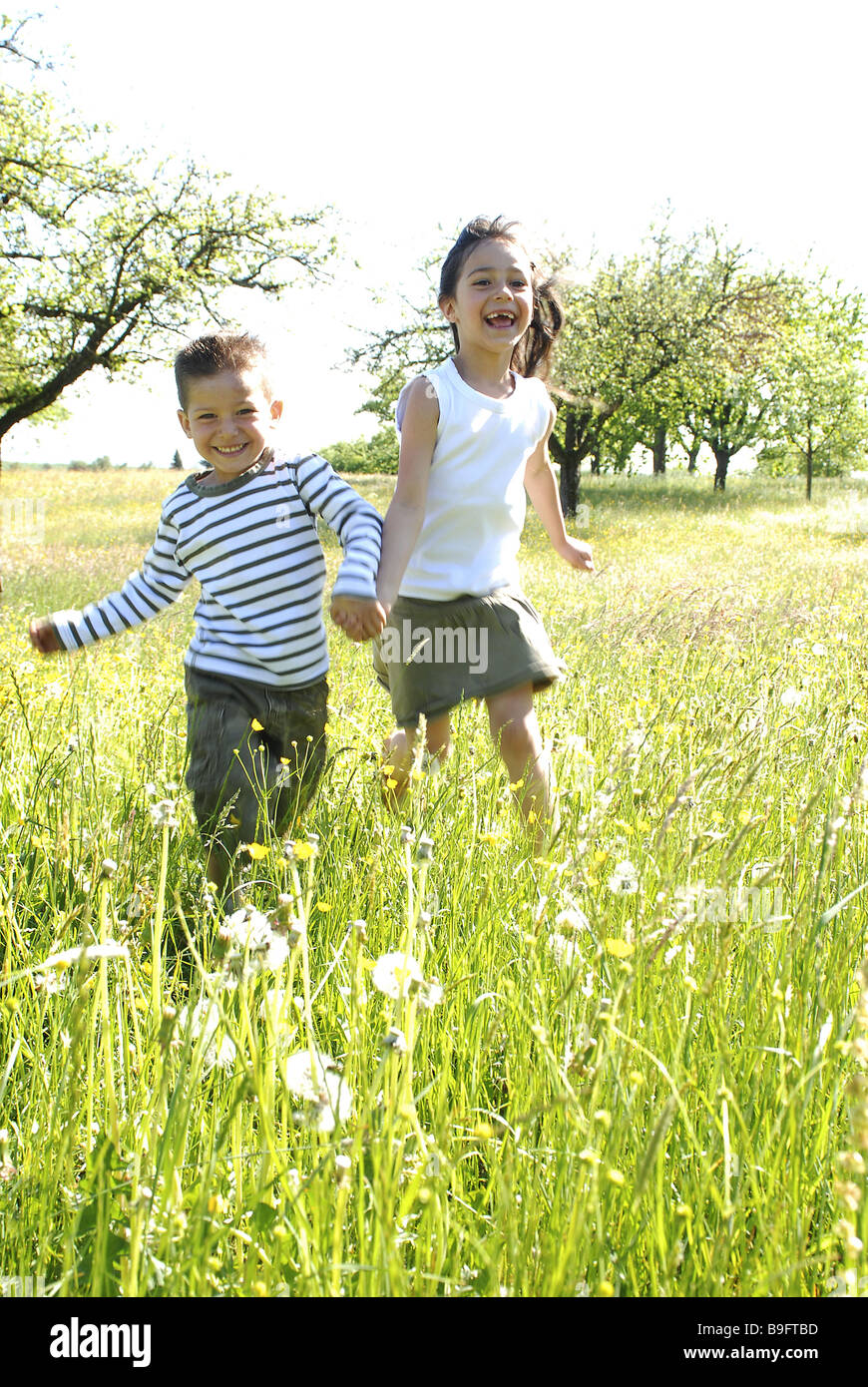 Children running meadow Stock Photo - Alamy