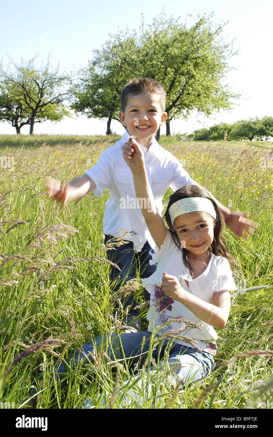 Children plays meadow Stock Photo - Alamy
