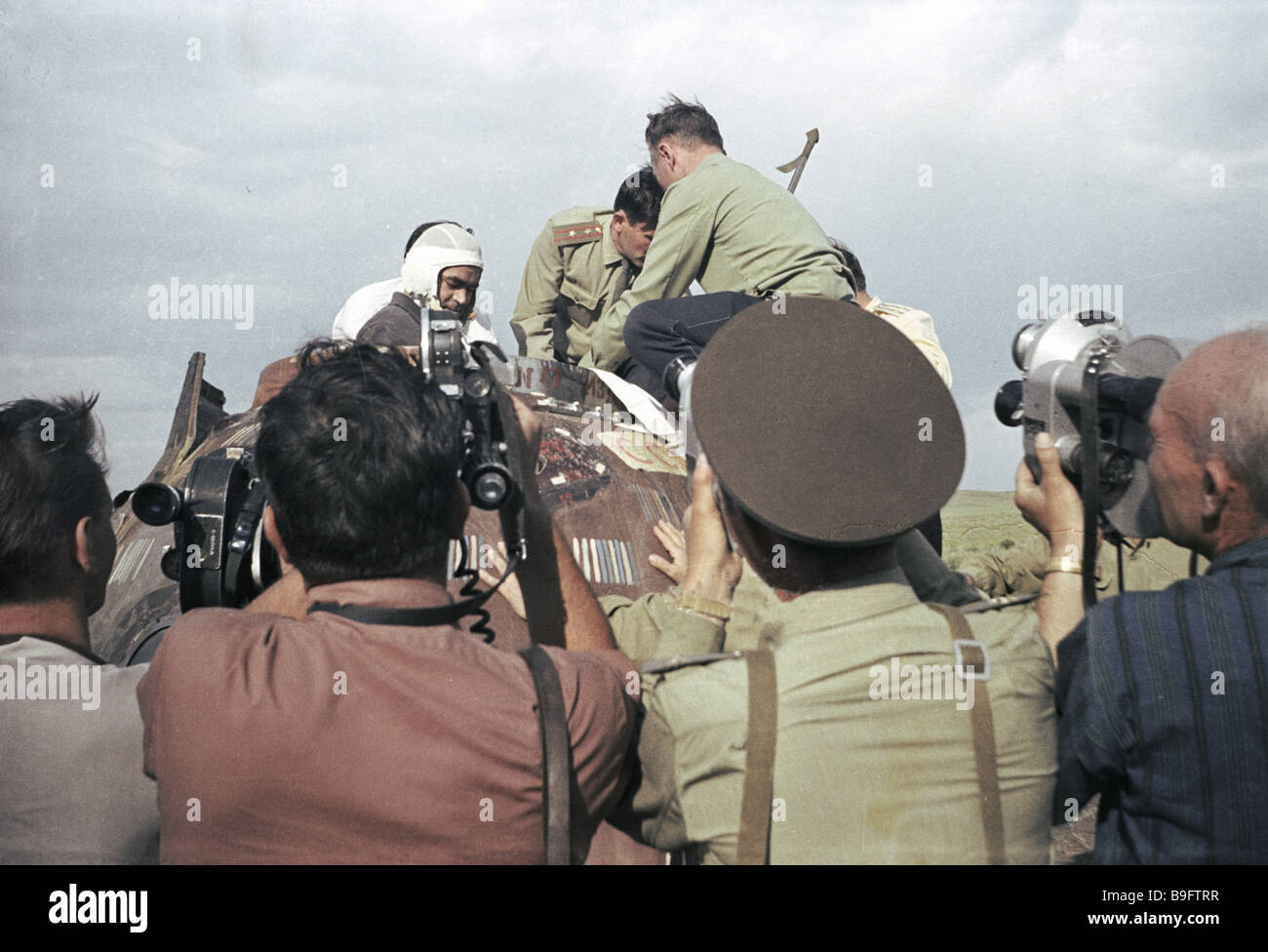Cosmonaut Andriyan Nikolayev in white helmet peers out of Soyuz 9 ...