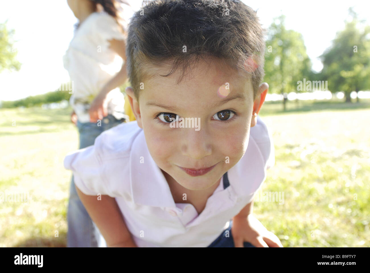 Children plays meadow portrait Stock Photo - Alamy