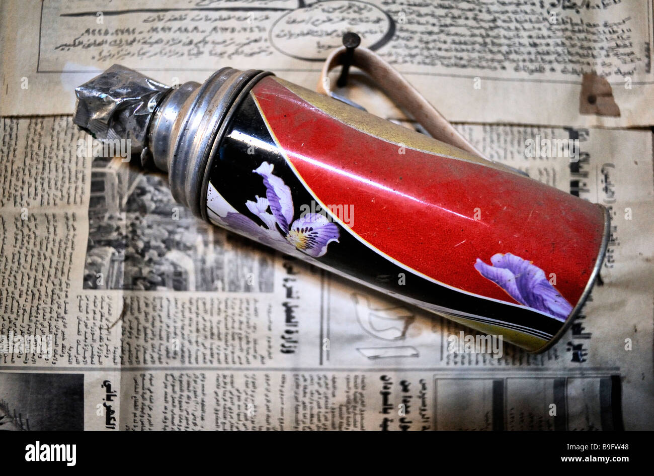 Chinese vacuum flask hanging on wall that is covered in newspapers, in ...