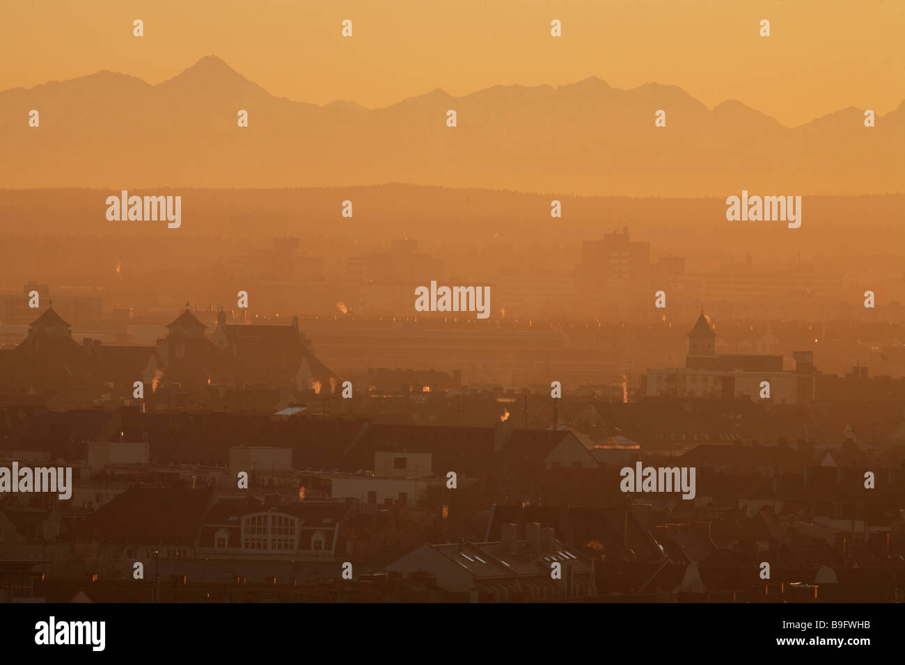 Germany Bavaria Munich city-overview mountains mist twilight Stock ...