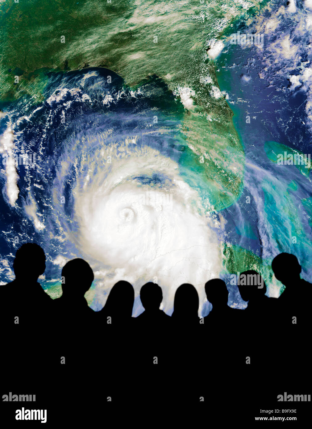 silhouette of eight people looking at satellite photo of Hurricane ...