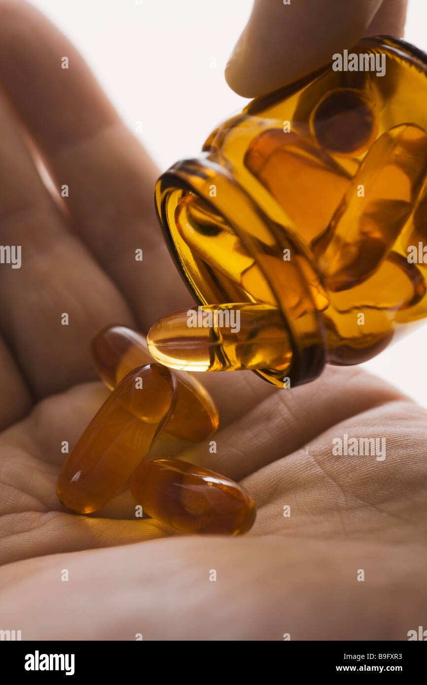 Hand with capsules hi-res stock photography and images - Alamy