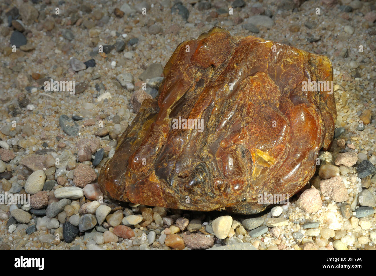 Raw Amber on sand Stock Photo - Alamy