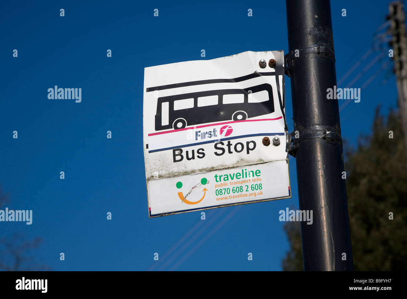 Bus stop sign damaged by collision Stock Photo - Alamy