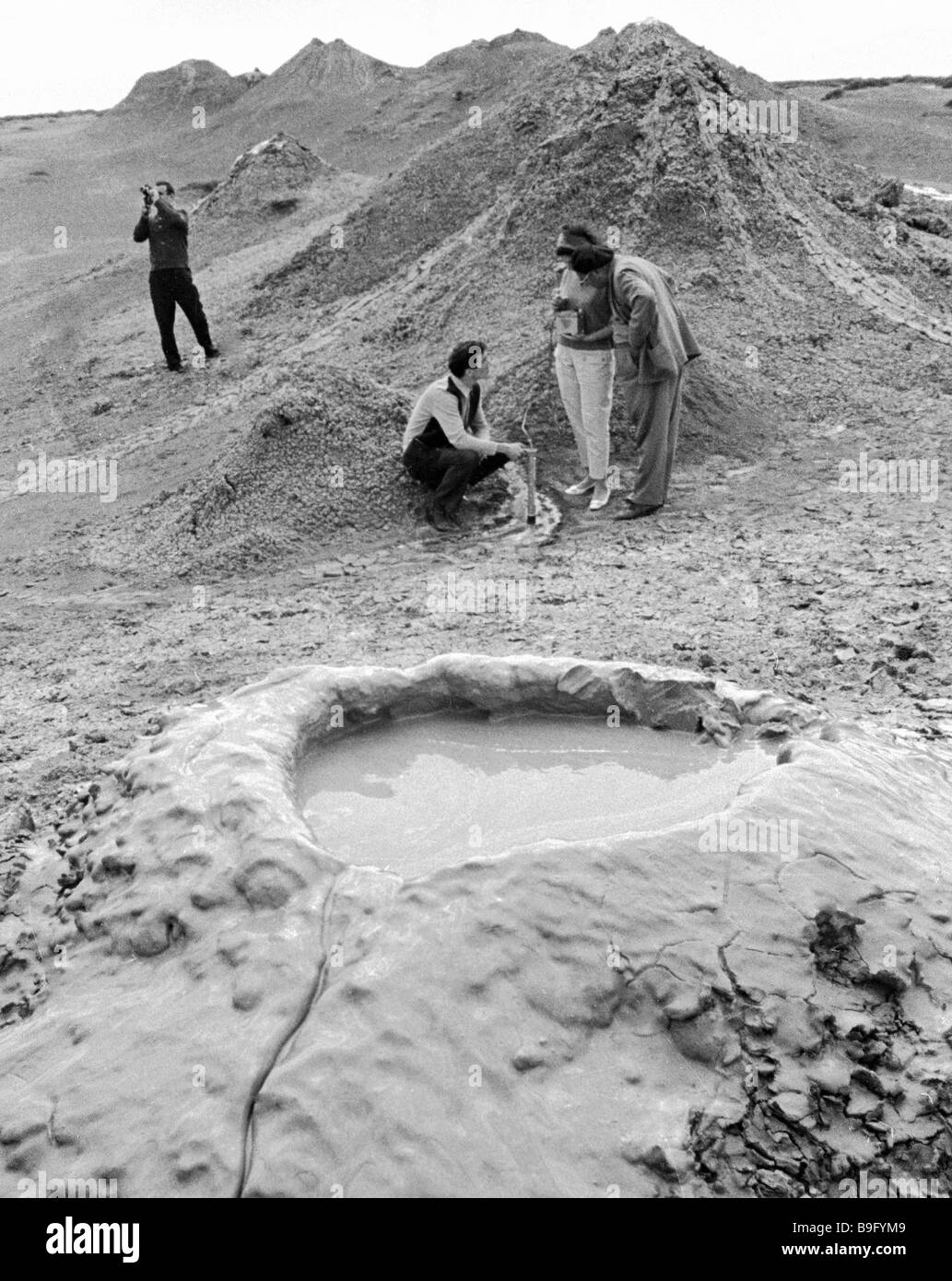 Geologists prospecting for oil investigating a mud volcano Stock Photo ...