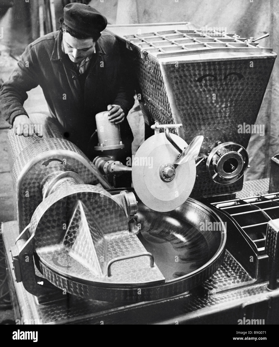 Worker of food industry machinery factory examines new multi role meat ...