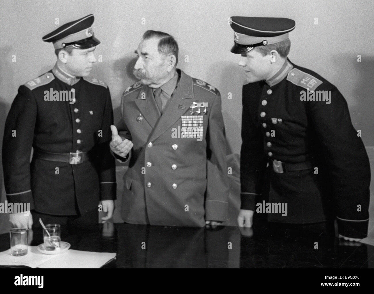 Soviet Union Marshal Semyon Budyonny center talks to the Suvorov ...