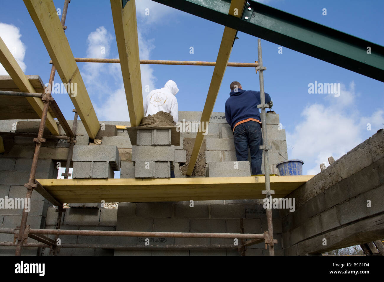 Builders reconstructing a house wall Stock Photo - Alamy