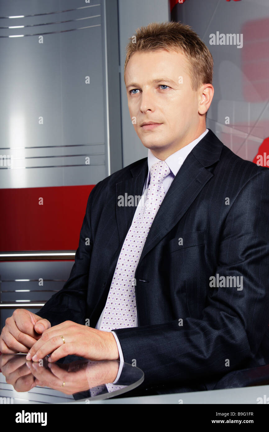 serious news presenter or television manager at the desk in office or ...