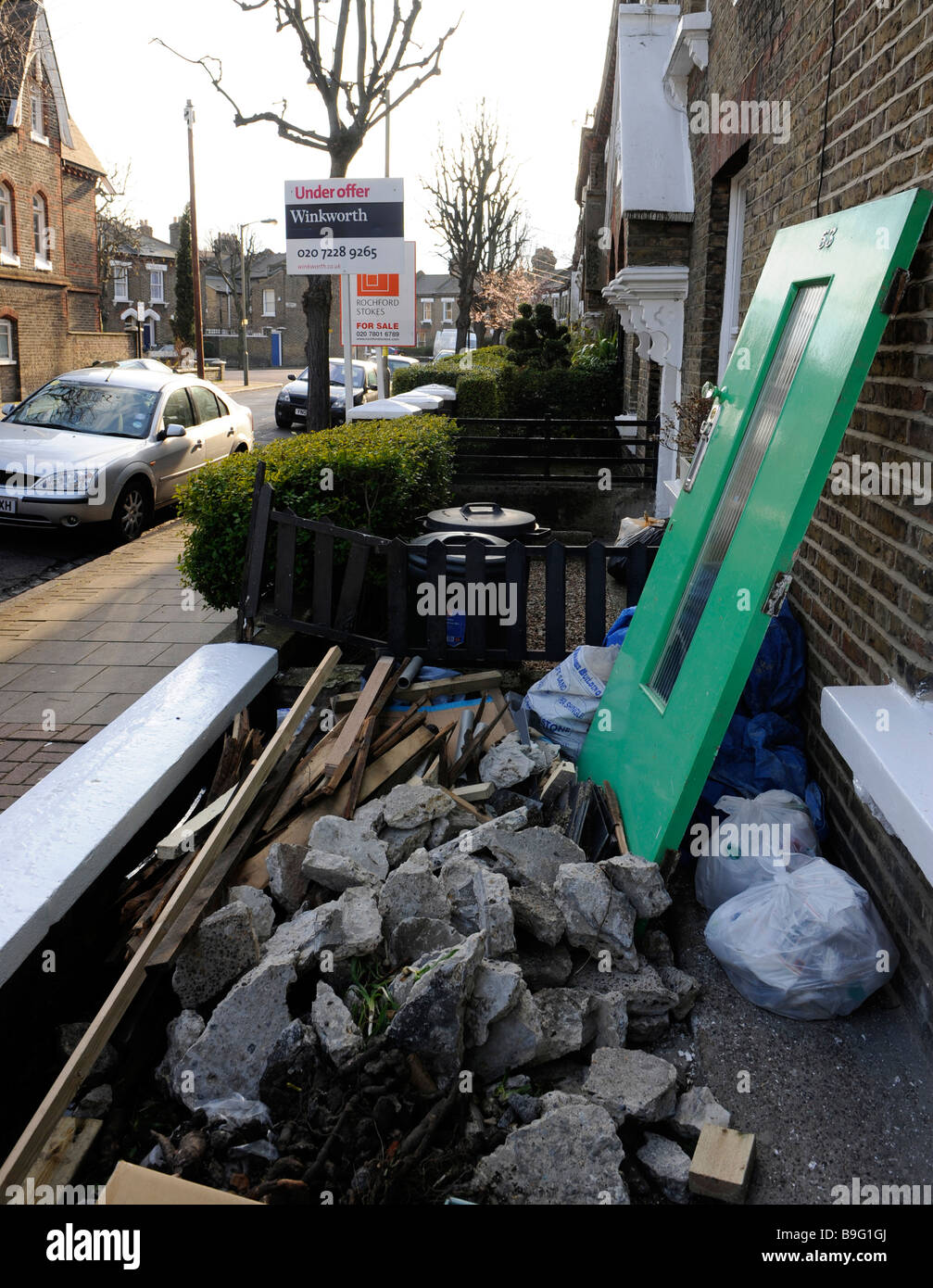 Rubbish, rubble, building waste outside a property being renovated in ...
