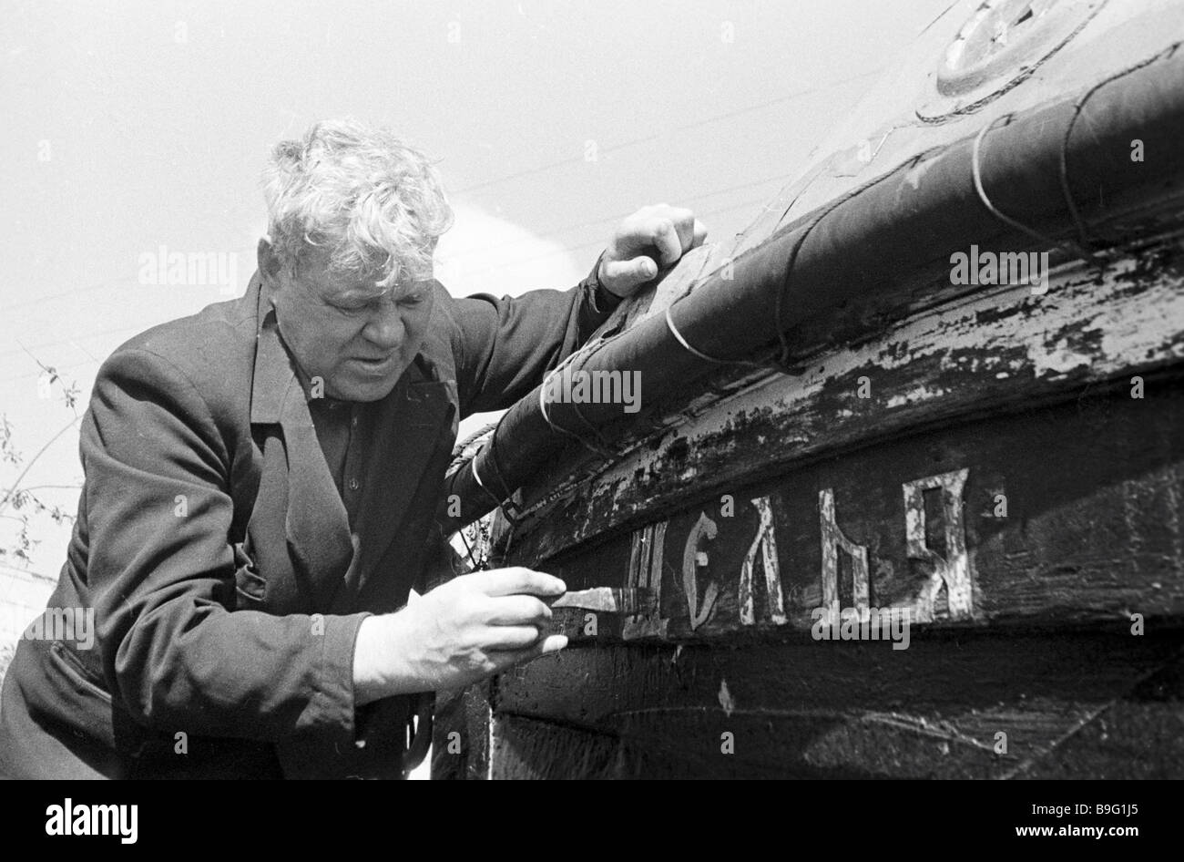 Polar traveler Dmitry Butorin preparing his boat for a voyage along the ...