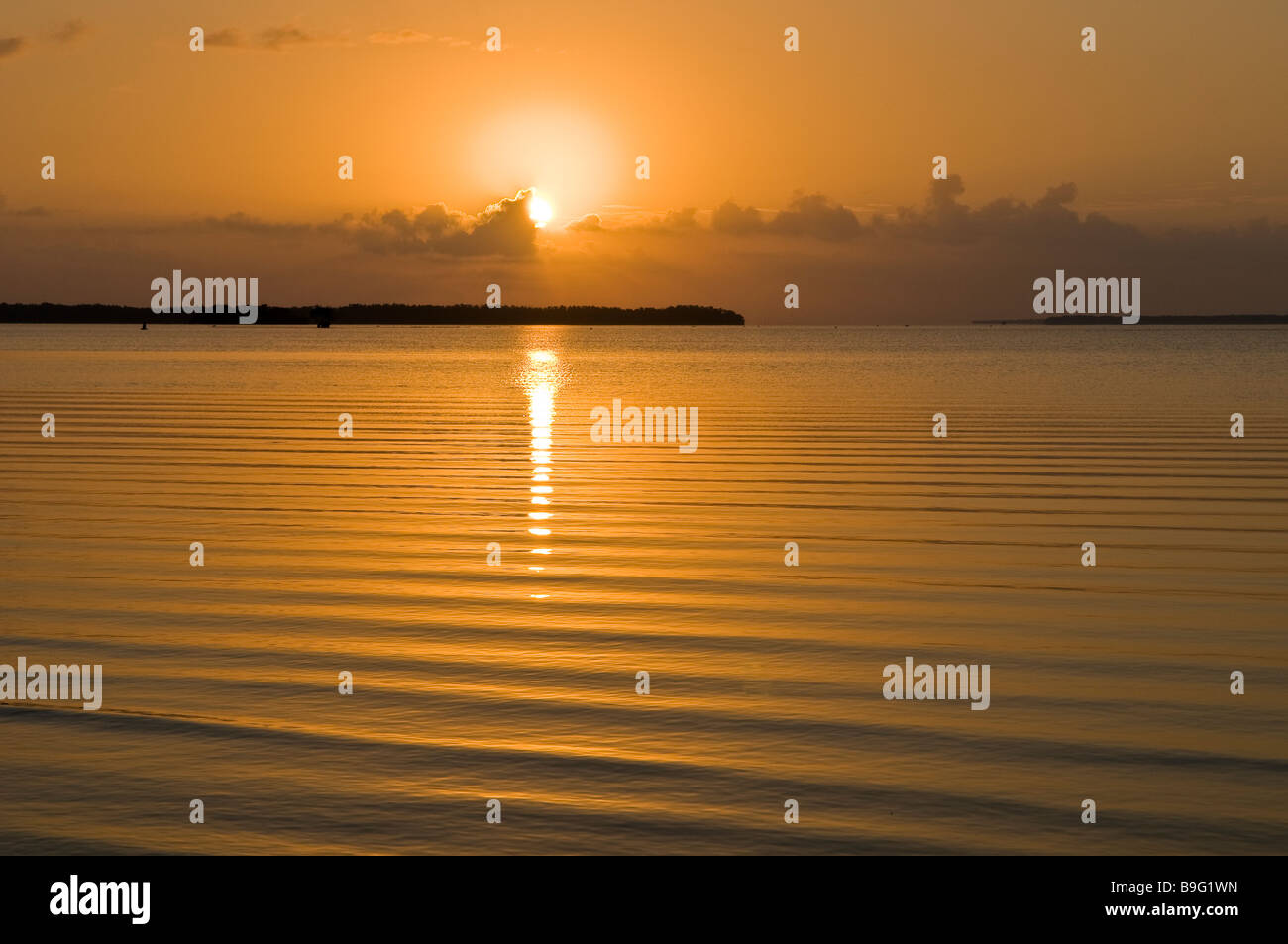Sun rises through clouds over mangrove islands in Florida Bay ...