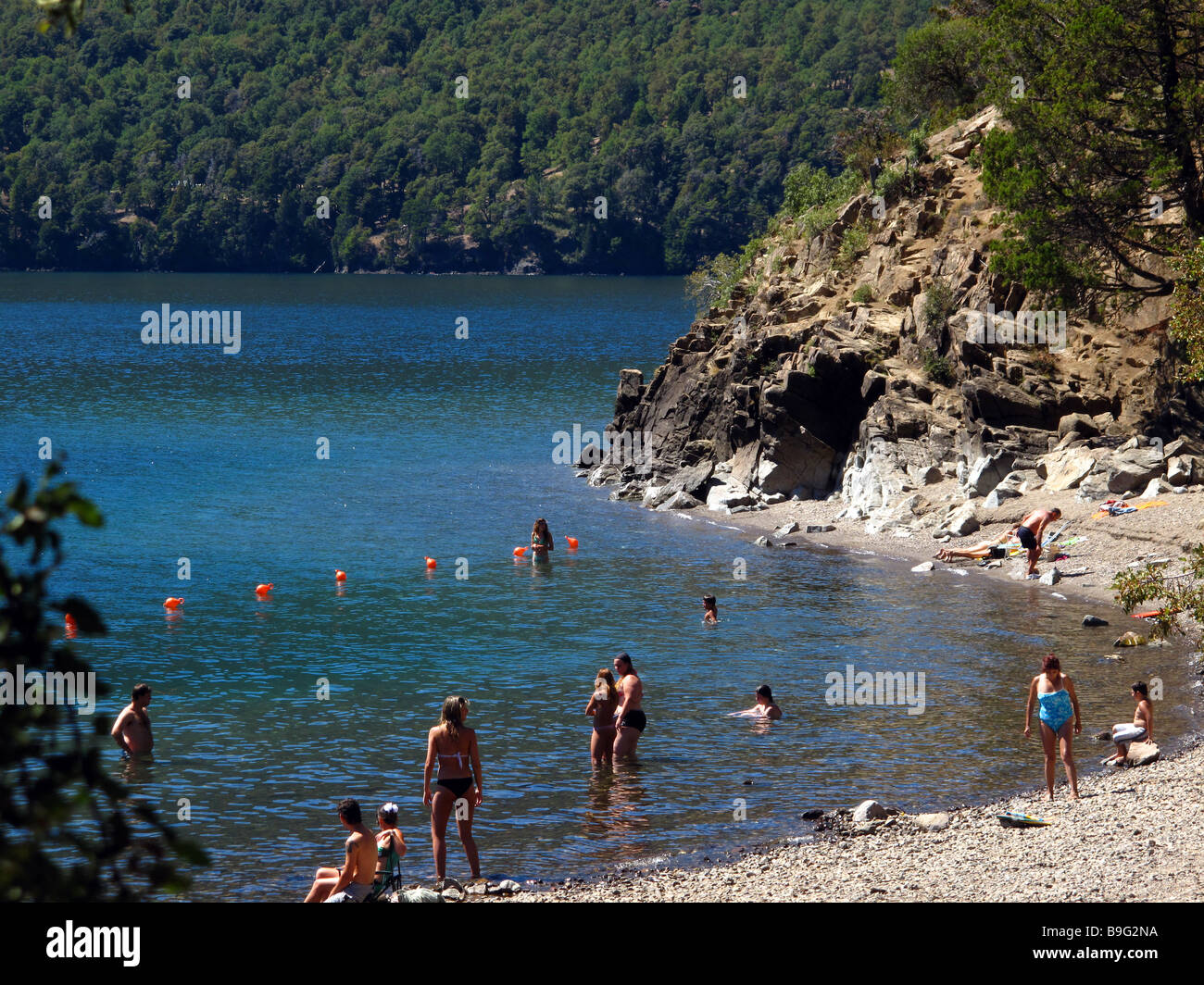 People enjoying a summer day at the beach in the lake Lacar, located in ...