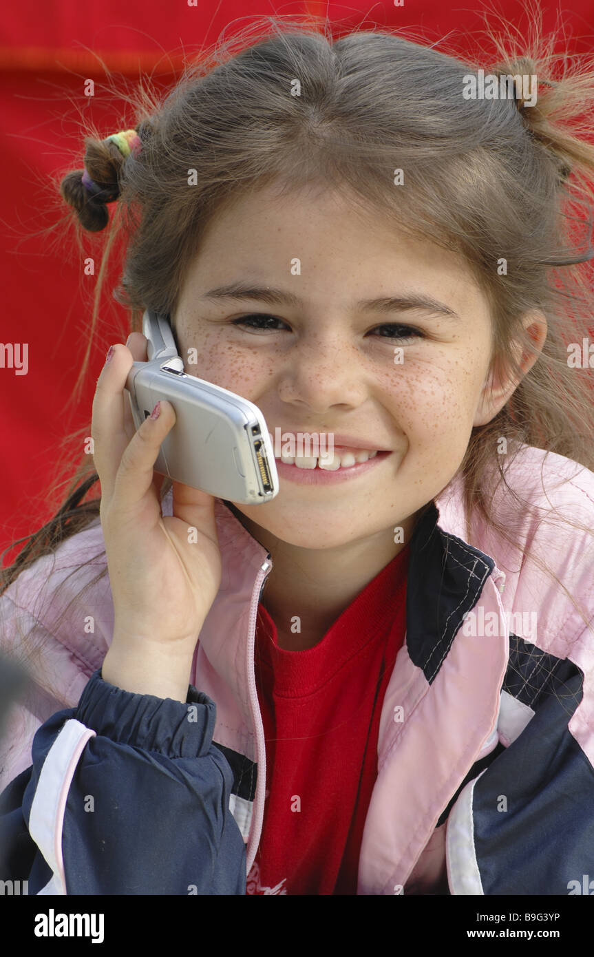 girl cheerfully cell phone smile telephones portrait people child ...