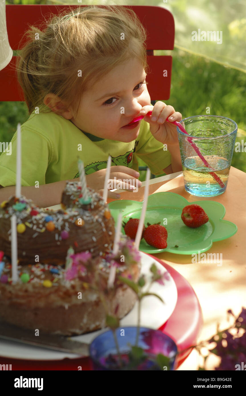 Child-birthday girl glass drinks straw portrait summer garden terrace ...