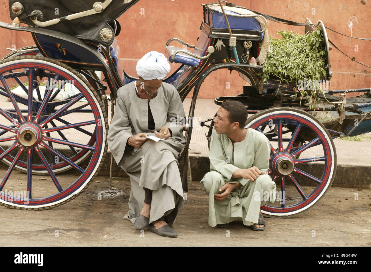Egypt Luxor Bazar carriage men conversation Stock Photo - Alamy
