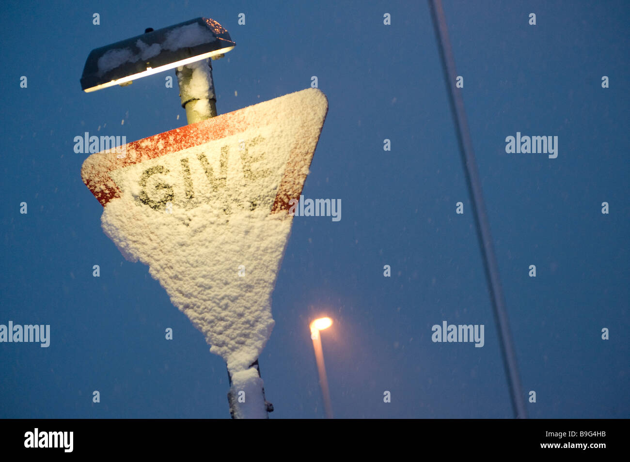 Give way road sign covered in snow on a winters day in england Stock ...