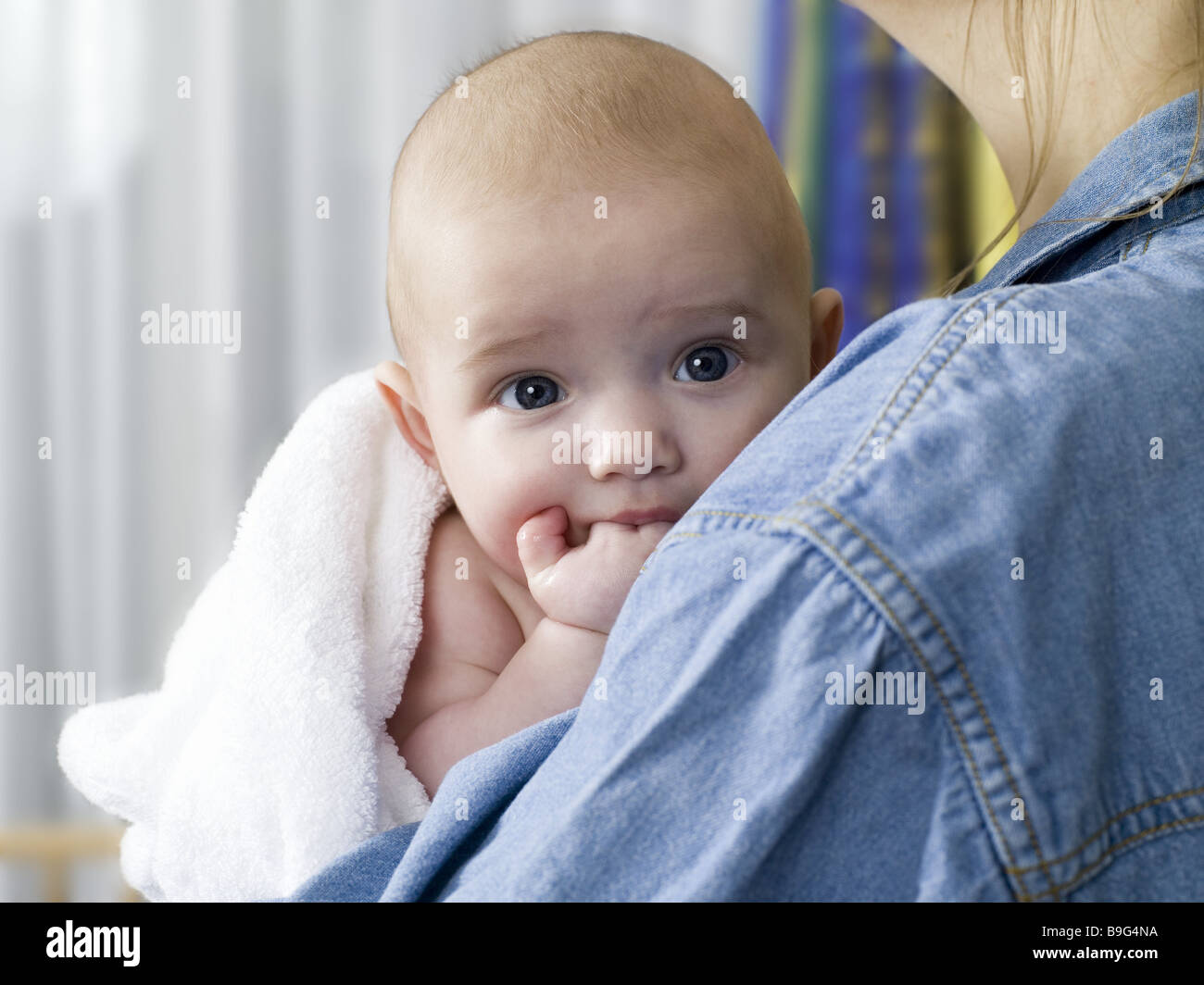 woman back view cautiously holding baby gaze shoulder portrait people ...