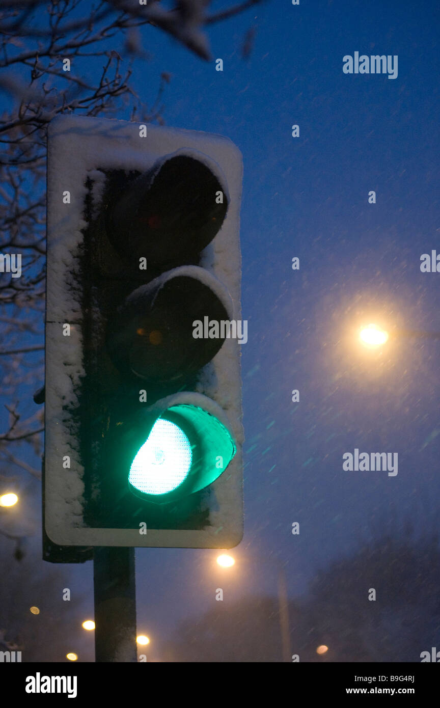Green traffic light covered in snow in england in the winter Stock ...