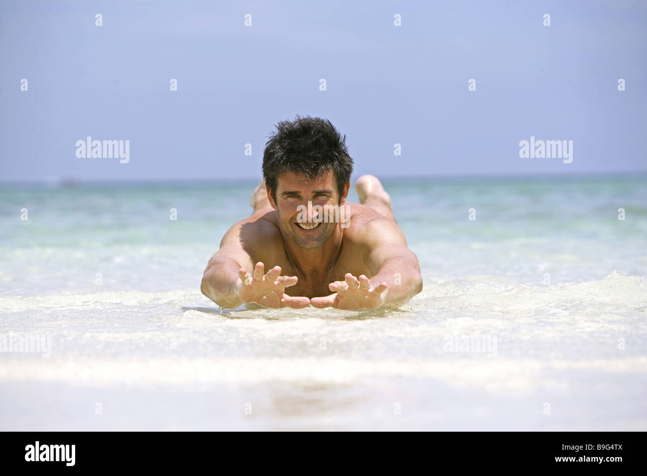 Man lake beach lying Stock Photo - Alamy